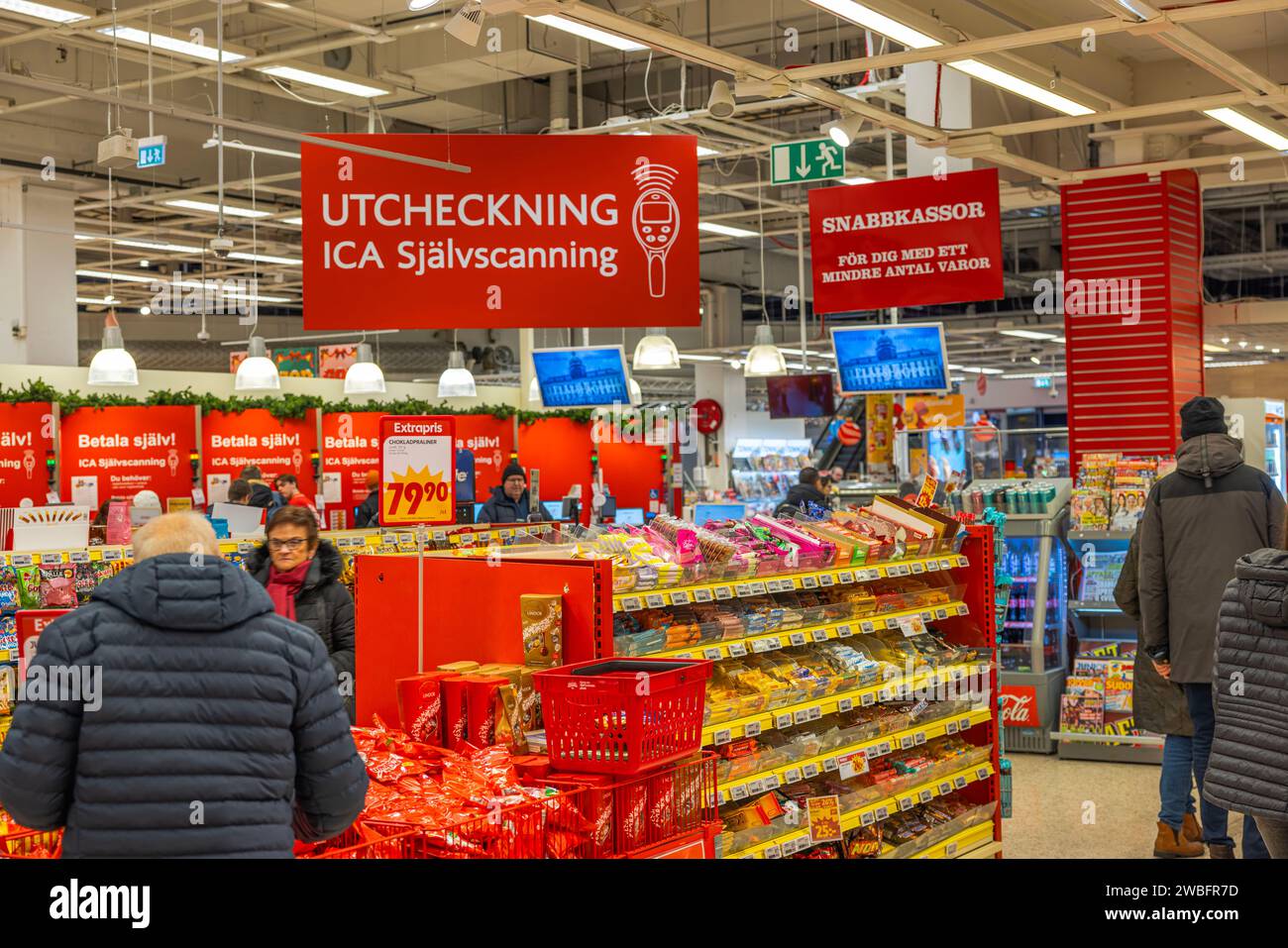 Interior view of a Swedish ICA supermarket with shoppers near shelves ...