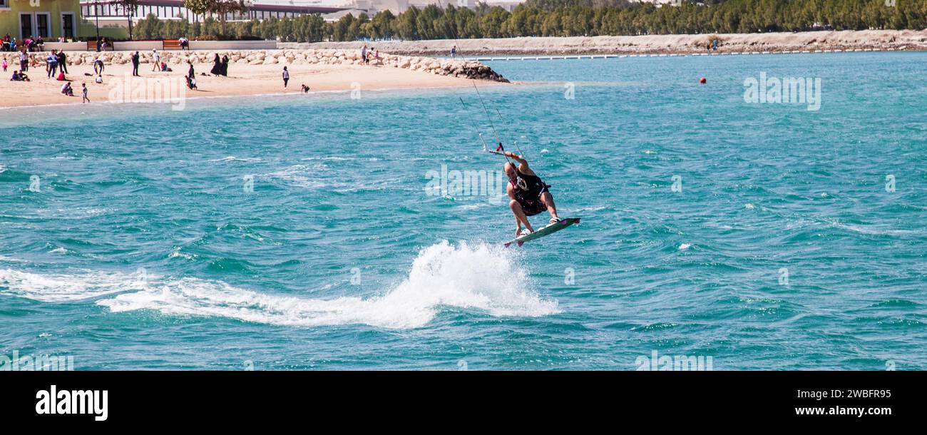 Doha, Qatar-February 14,2016 Kiteboarding on the waters of an ...