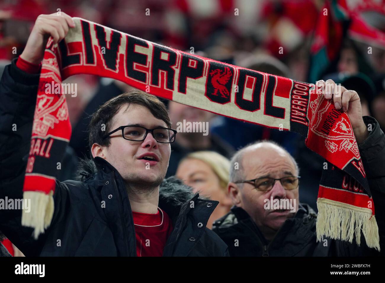 Liverpool fans sing and hold up scarves prior to the EFL Cup first leg ...