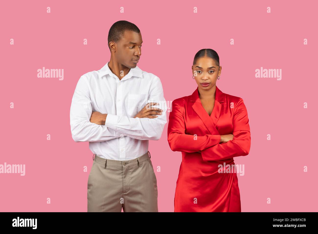 Black man and woman in serious stance, crossed arms, white and red ...