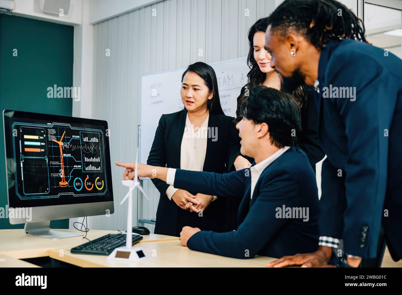 Colleagues with diverse skills and backgrounds convene around a desktop ...