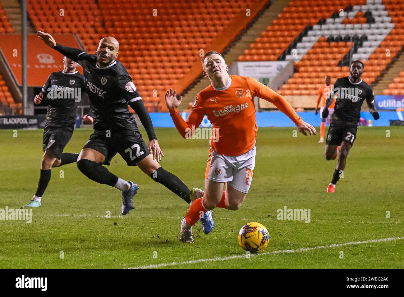 Shayne Lavery of Blackpool goes down under the challenge of Jasper Moon ...