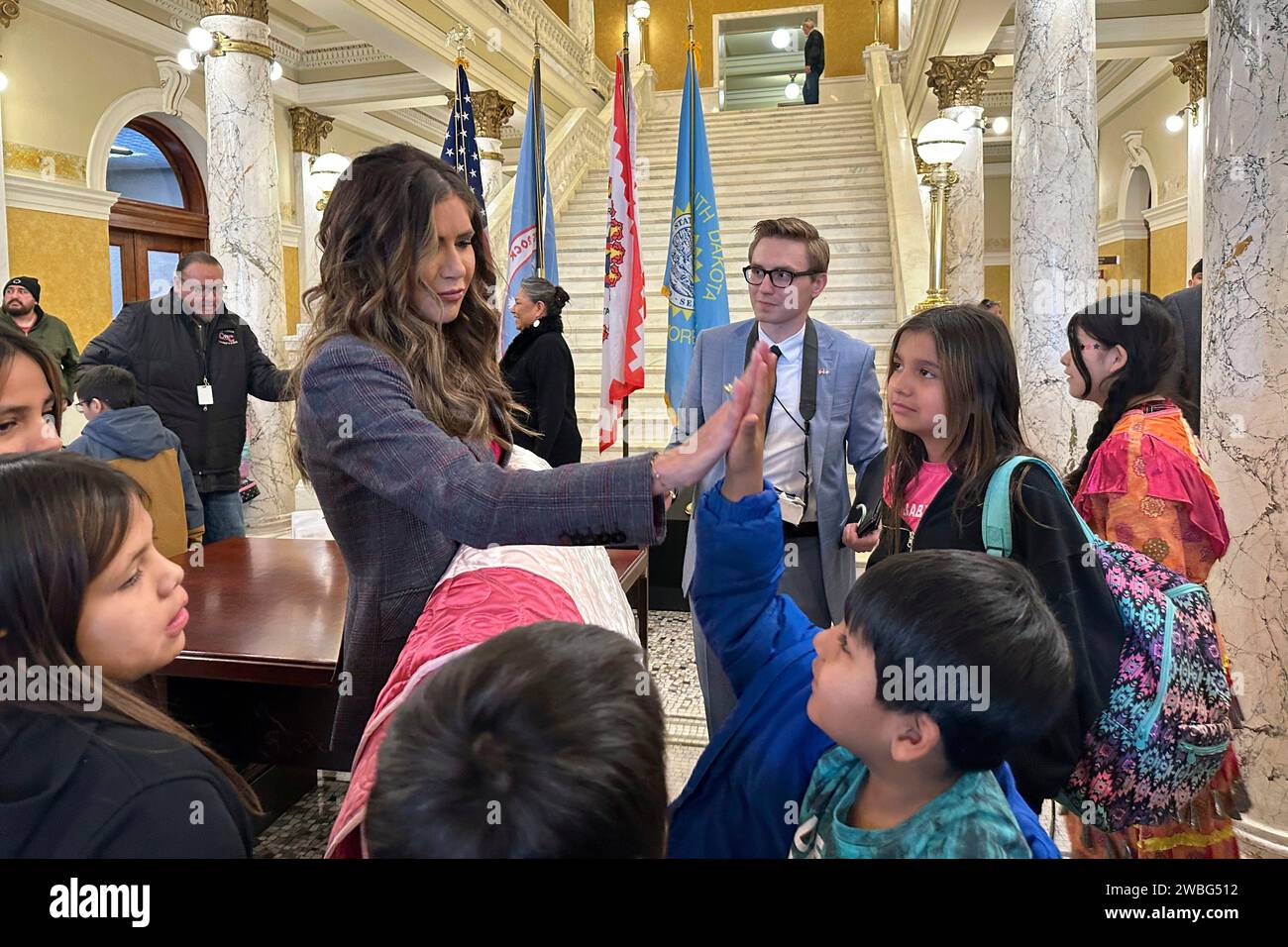 South Dakota Republican Gov. Kristi Noem greets children after a ...