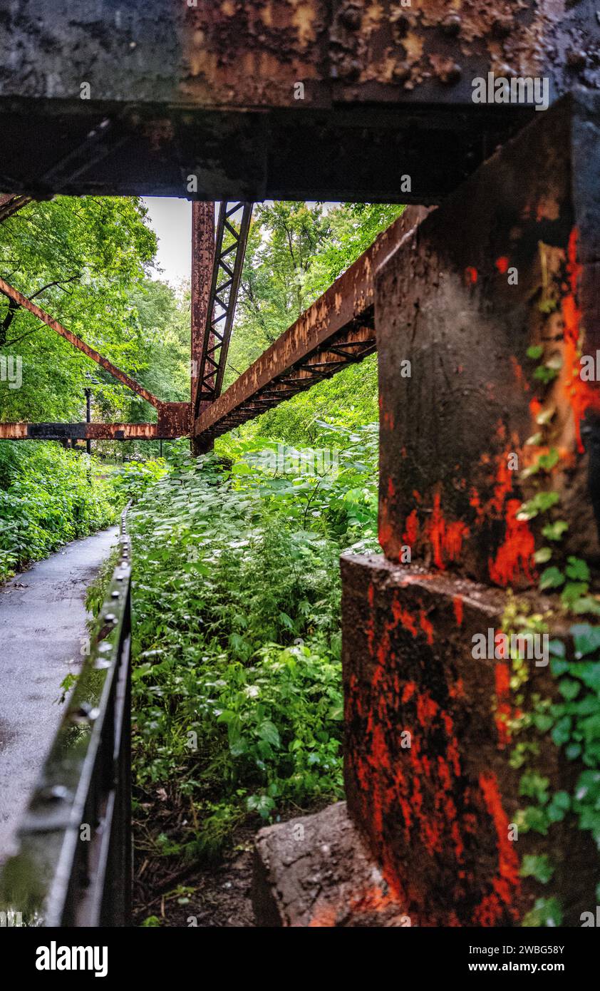 A close-up image of a large, weathered steel structure with signs of ...