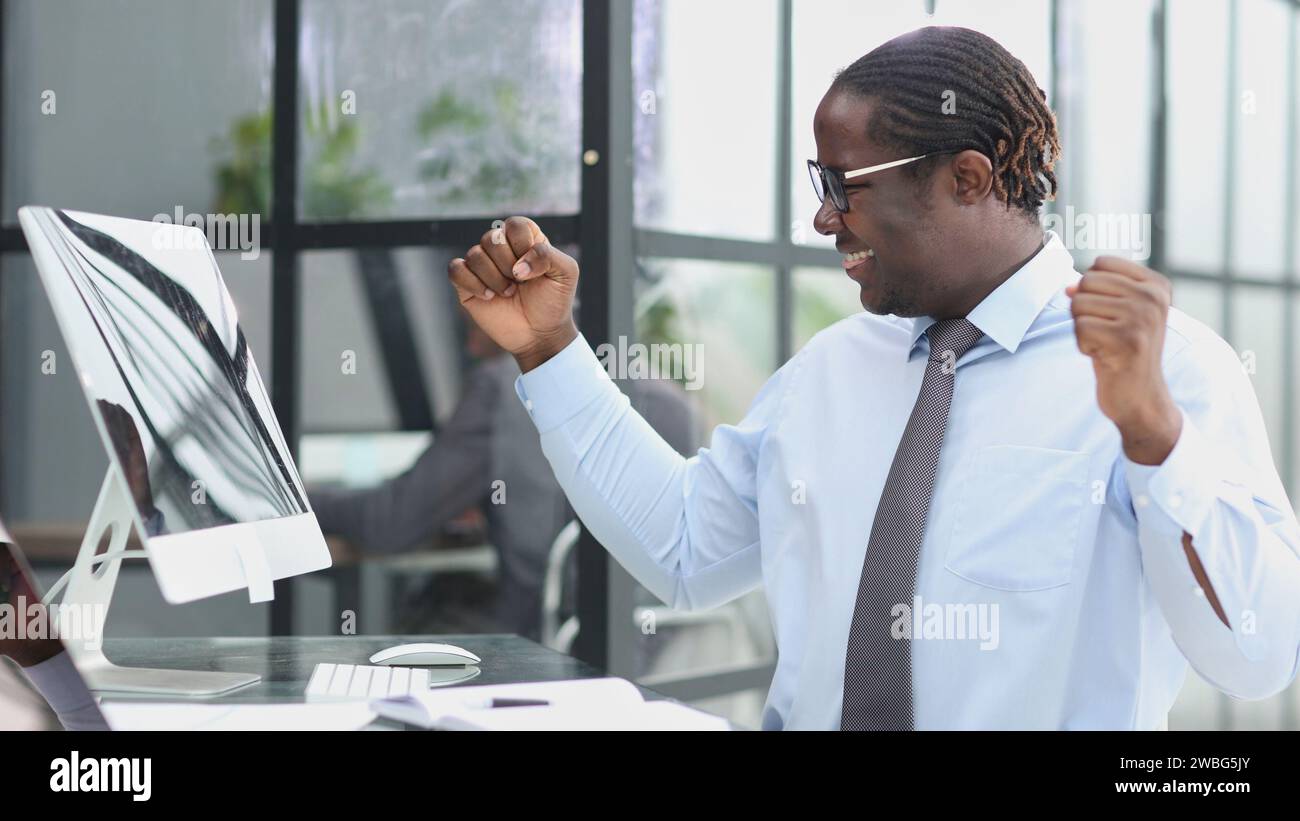 happy man working in the office. raised his hands joyfully Stock Photo ...