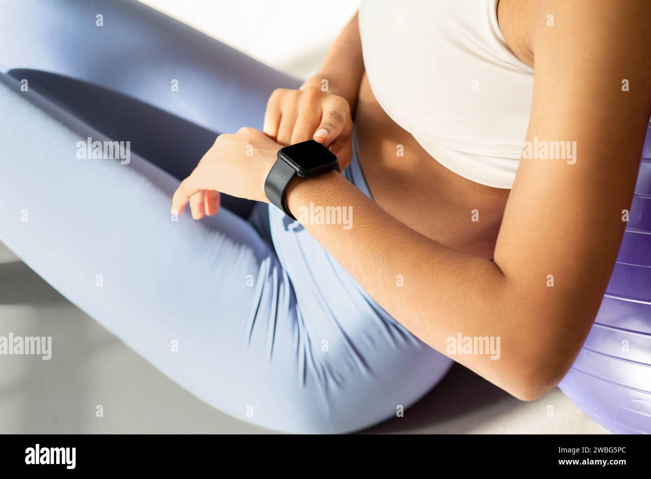 Close-up of a fitness-focused woman checking her smartwatch after a ...