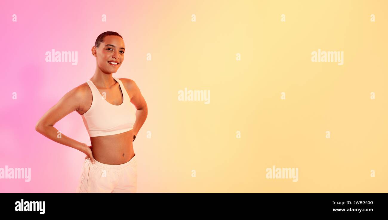 A radiant woman with a beaming smile poses confidently, hands on hips ...