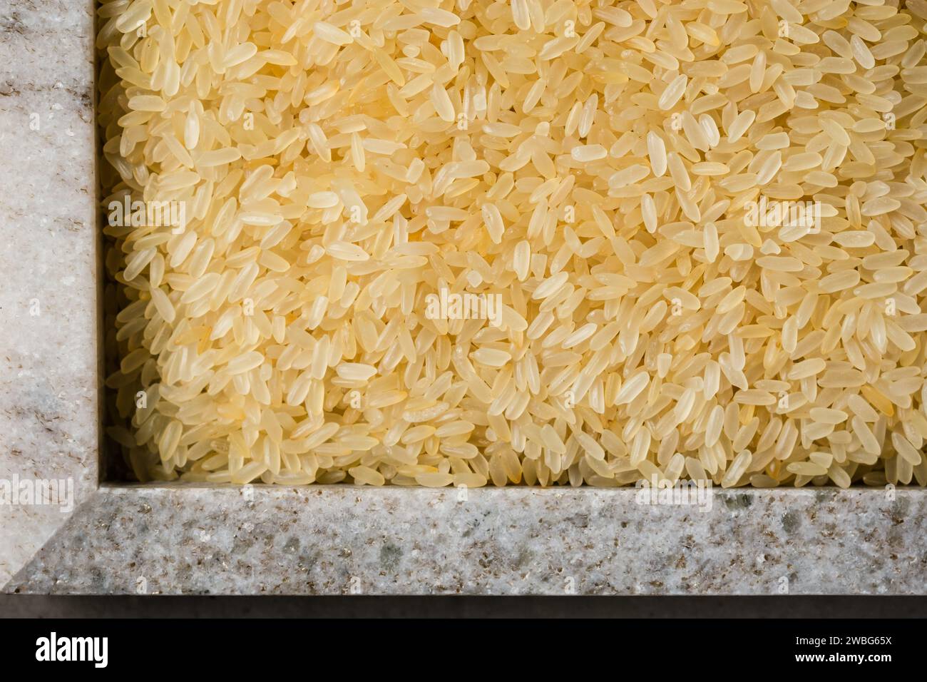 Rice groats in a bowl. Raw uncooked rice Stock Photo - Alamy