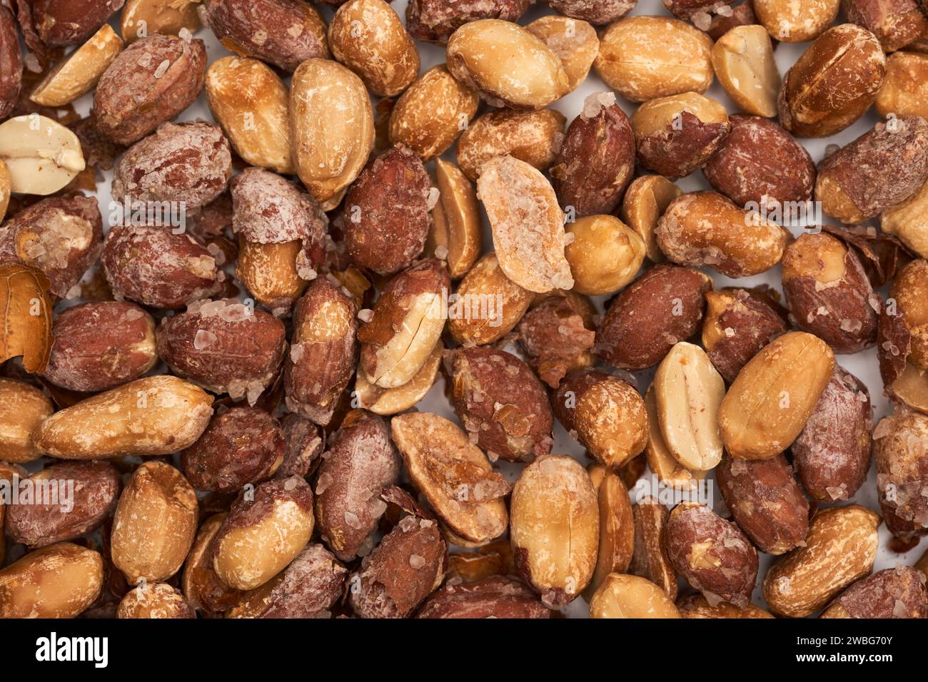 Oven baked salted peanuts in red skin, closeup studio shot Stock Photo ...
