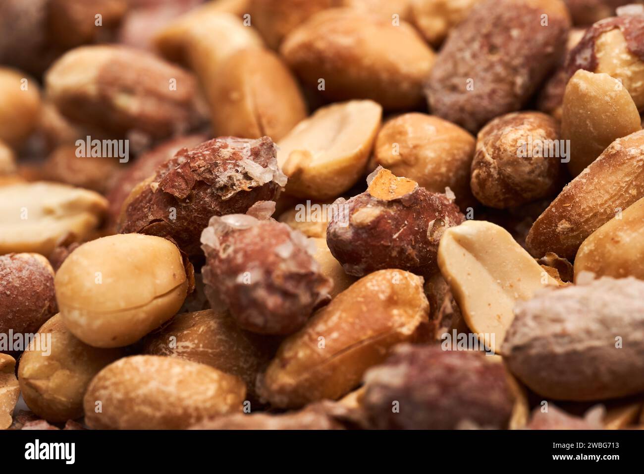Oven baked salted peanuts in red skin, closeup studio shot Stock Photo ...