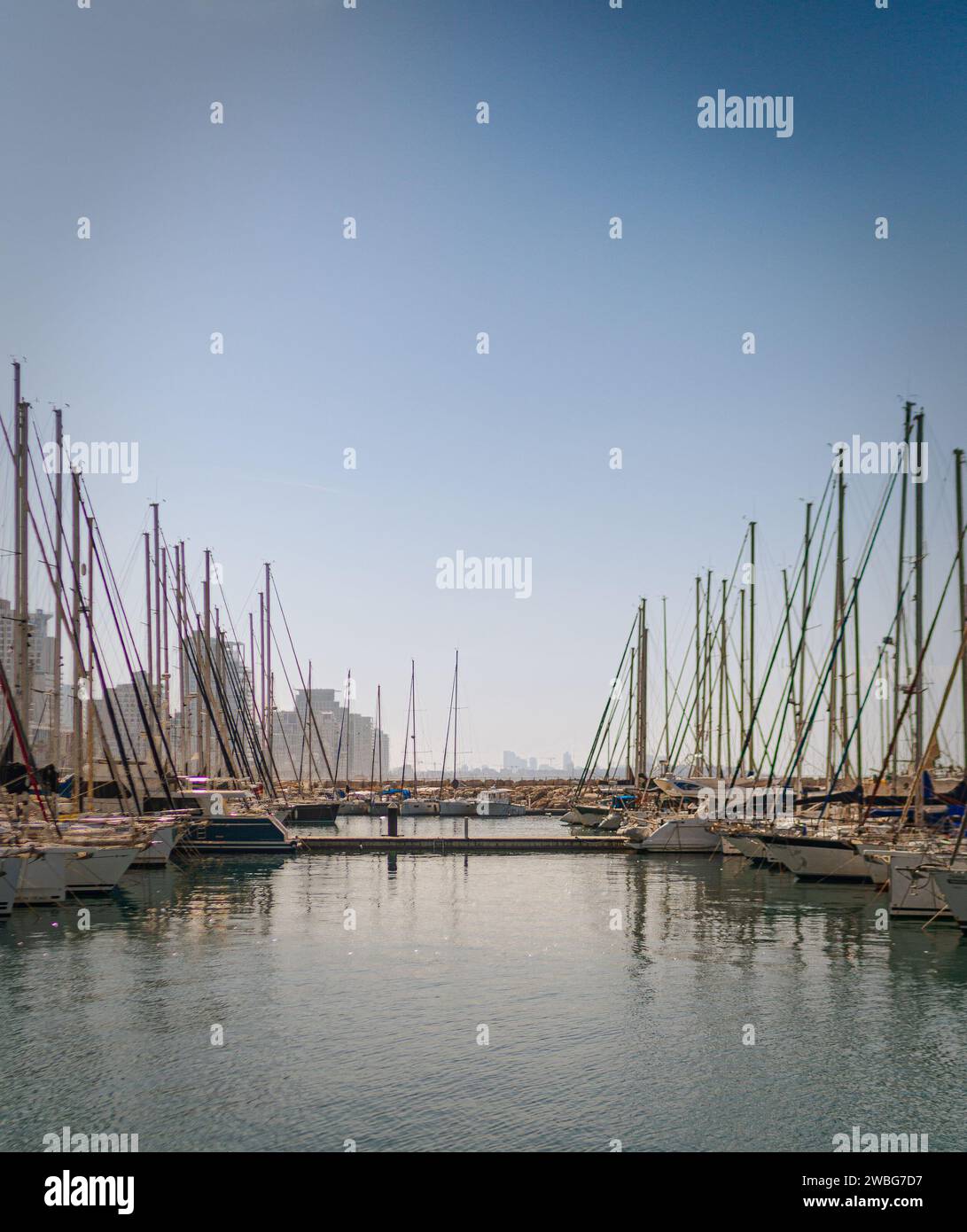 A vibrant scene of multiple boats docked at the shoreline, with people ...