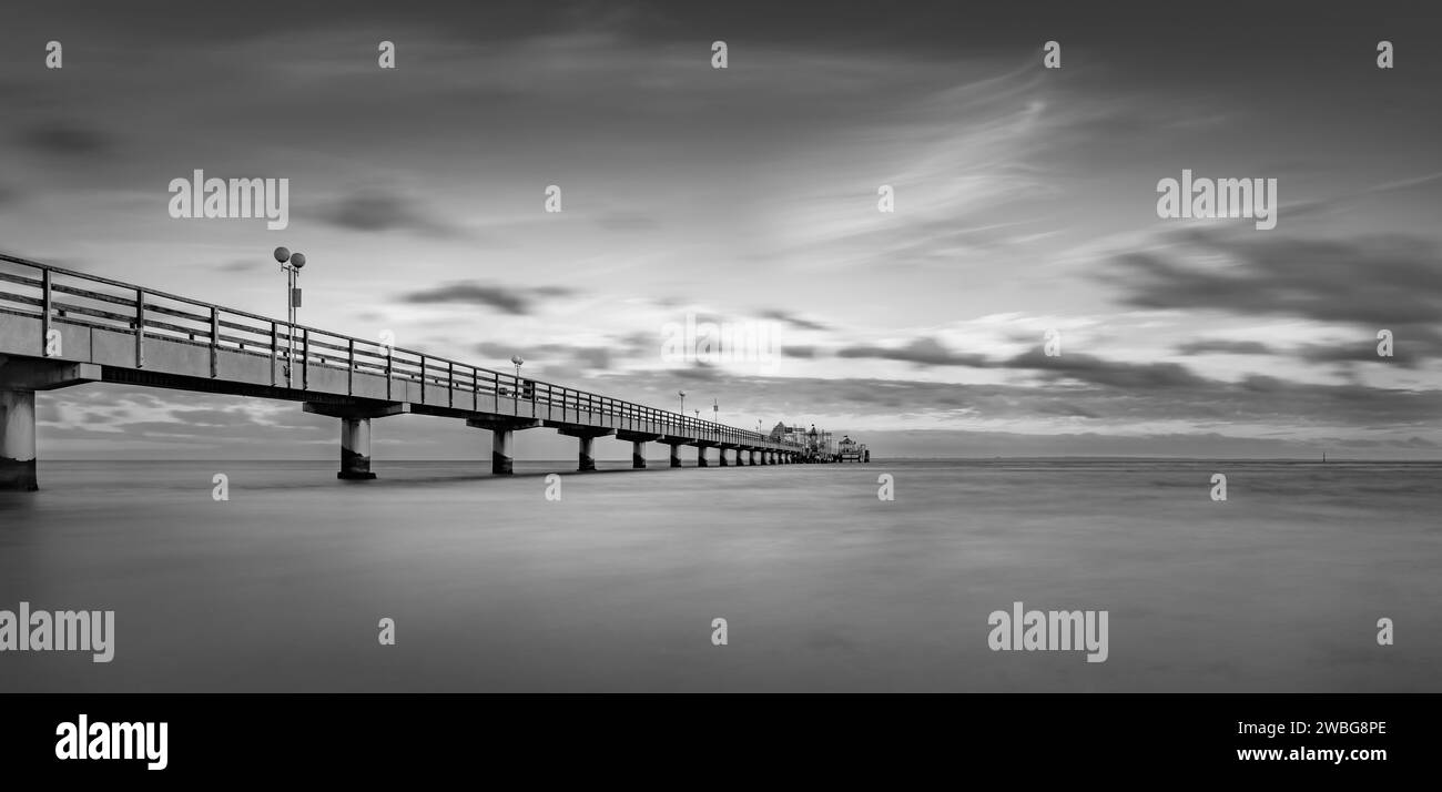 This is a stunning long exposure photograph of a pier jutting out into ...