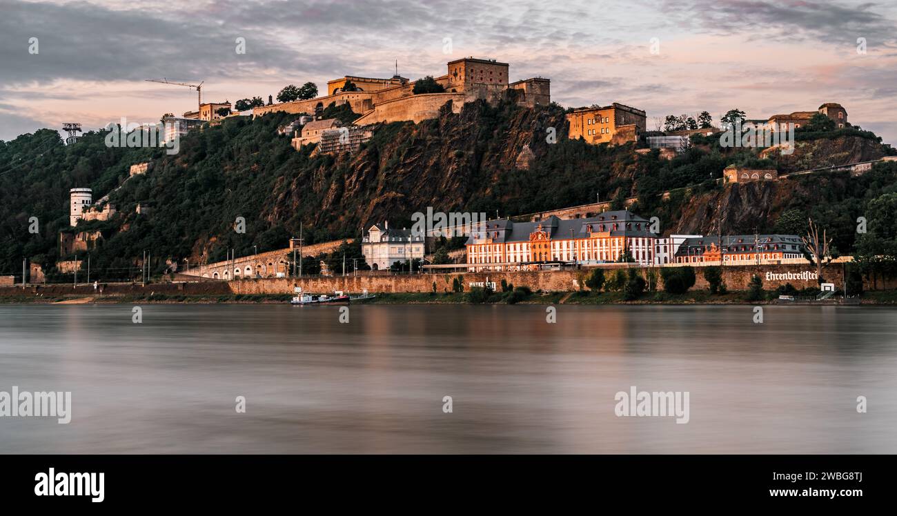 A grand stone castle perched atop a lush green hill overlooking a ...