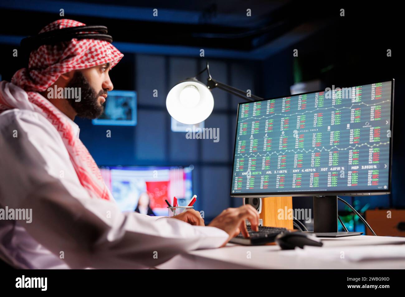 A professional Arab businessman works diligently at his desk engaged in ...