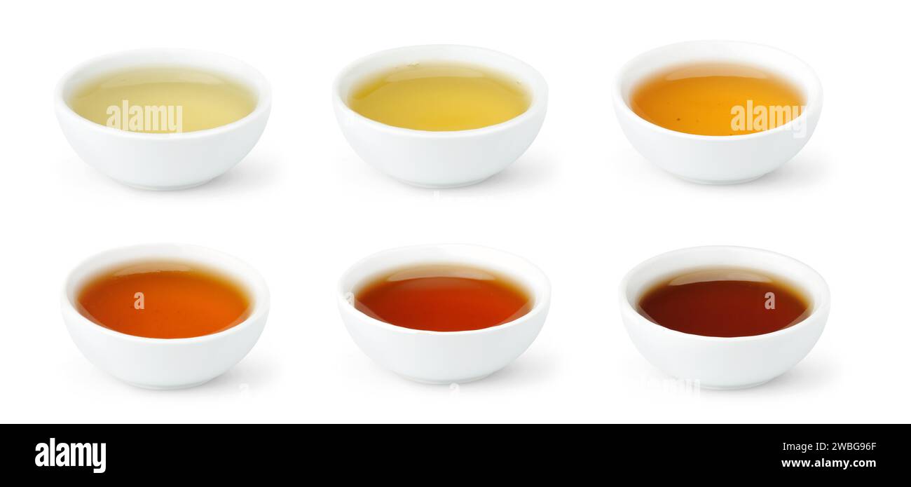 Brewed Chinese teas of different color in white bowls, isolated on ...