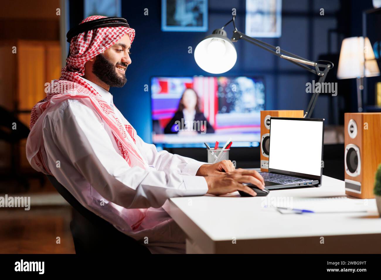 Middle Eastern man using his digital laptop that displays a blank ...