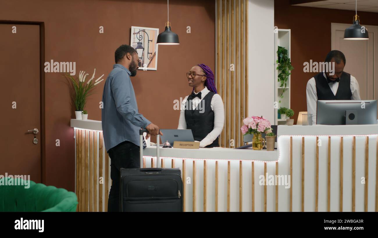 Person does check in at reception, entering five star hotel and signing ...