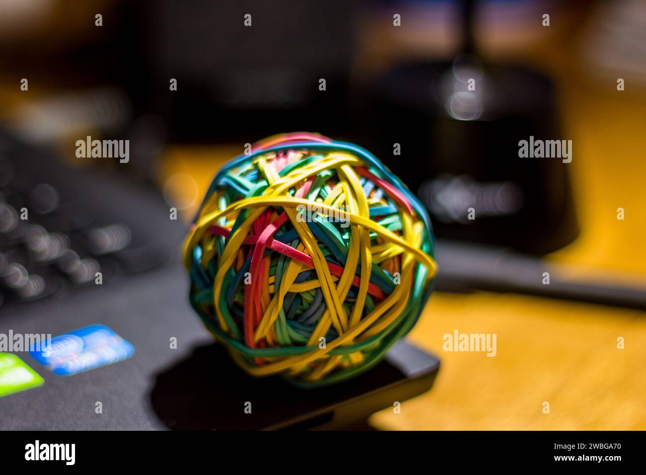 A ball made of multi-colored rubber bands lies on a laptop Stock Photo ...