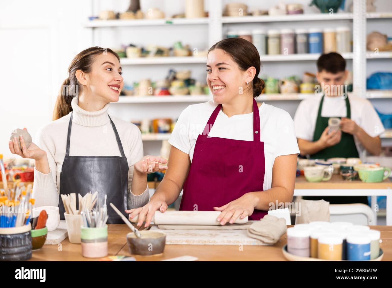Joyous young women sculpting handmade cups Stock Photo - Alamy