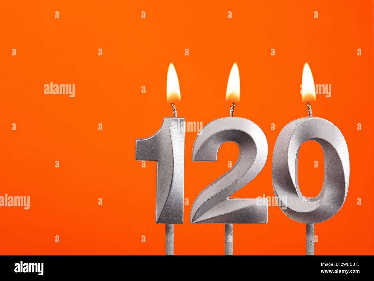 Candle number 120 - Birthday in orange background Stock Photo - Alamy