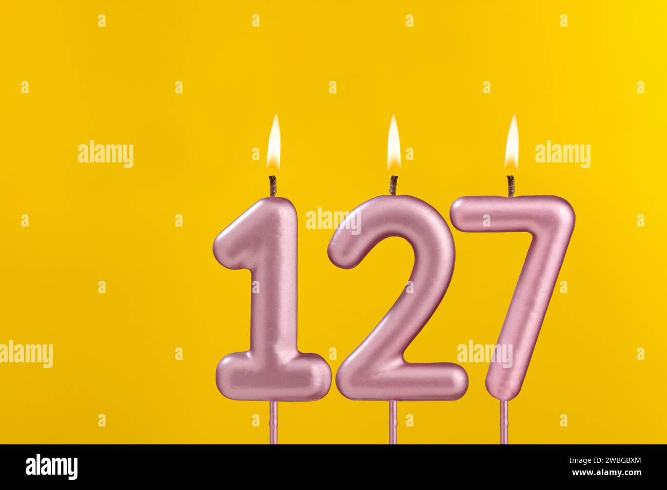 Birthday candle number 127 - Birthday celebration on yellow background ...