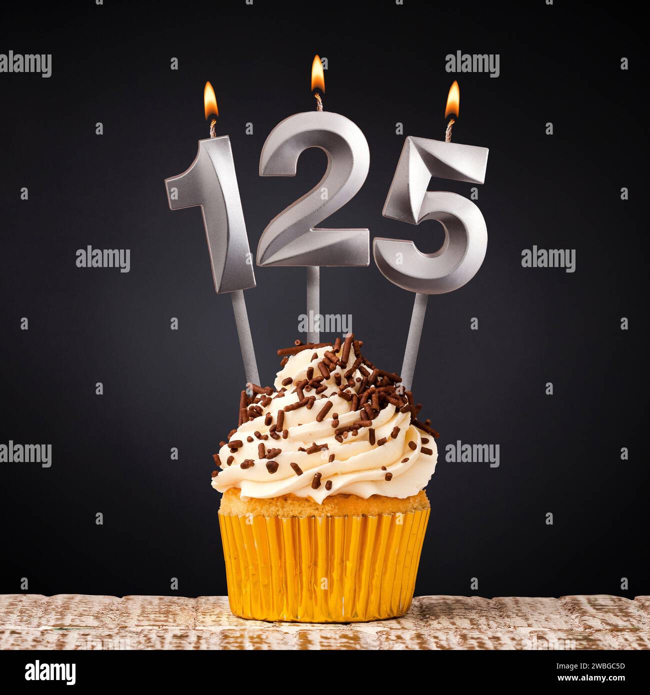 Birthday candle number 125 - Anniversary cupcake on black background ...
