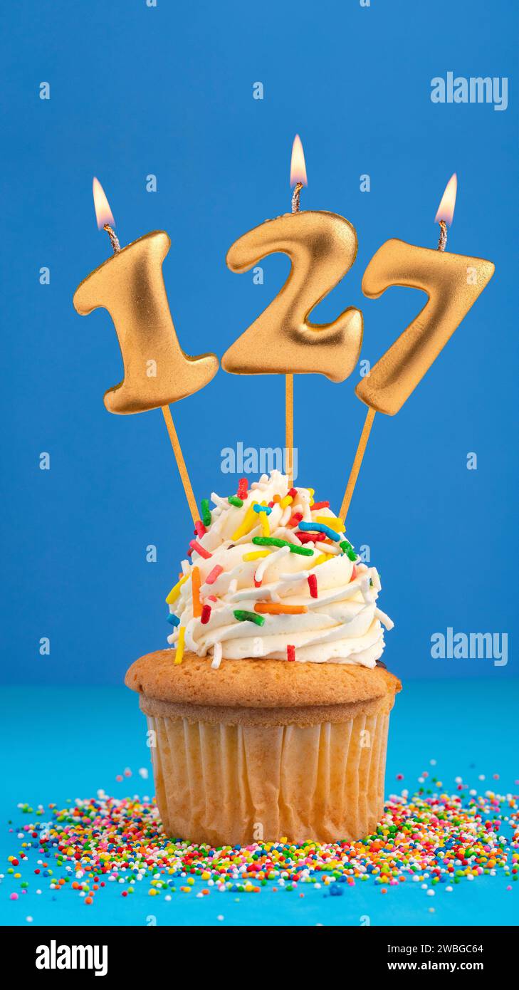 Candle number 127 - Cake birthday in blue background Stock Photo - Alamy