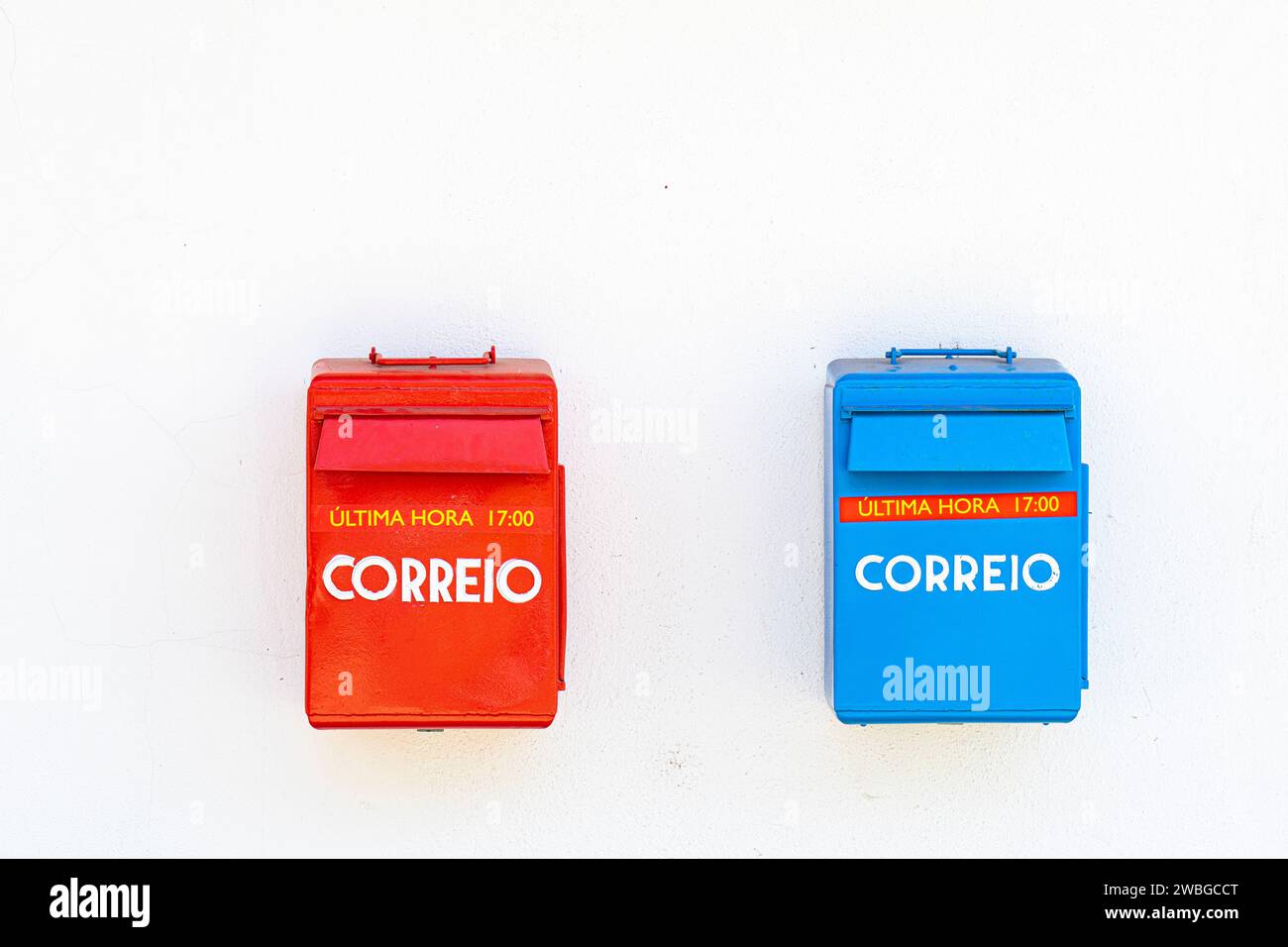 two mailboxes, one red plain mail, one blue express mail under white ...