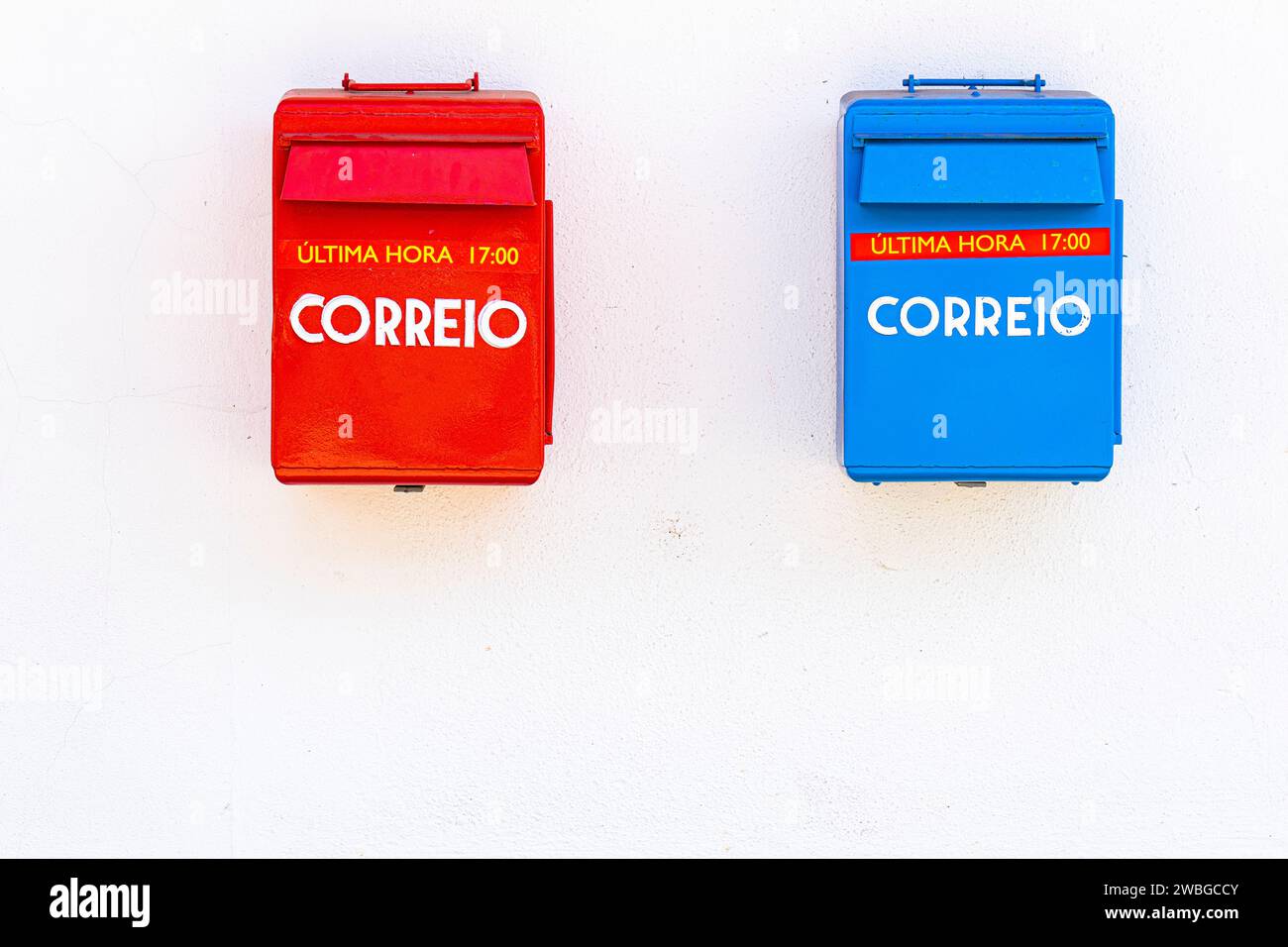 two mailboxes, one red plain mail, one blue express mail under white ...