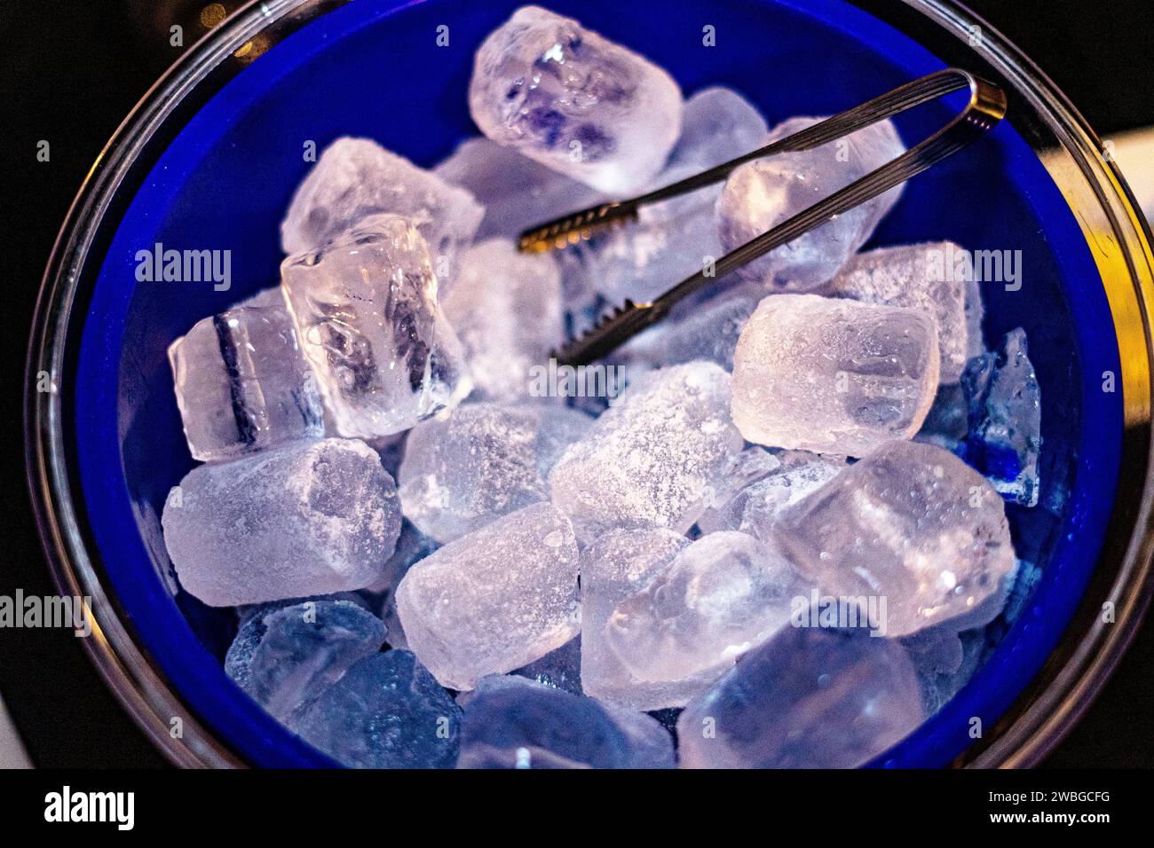 blue bucket with various ice cubes and tongs Stock Photo - Alamy