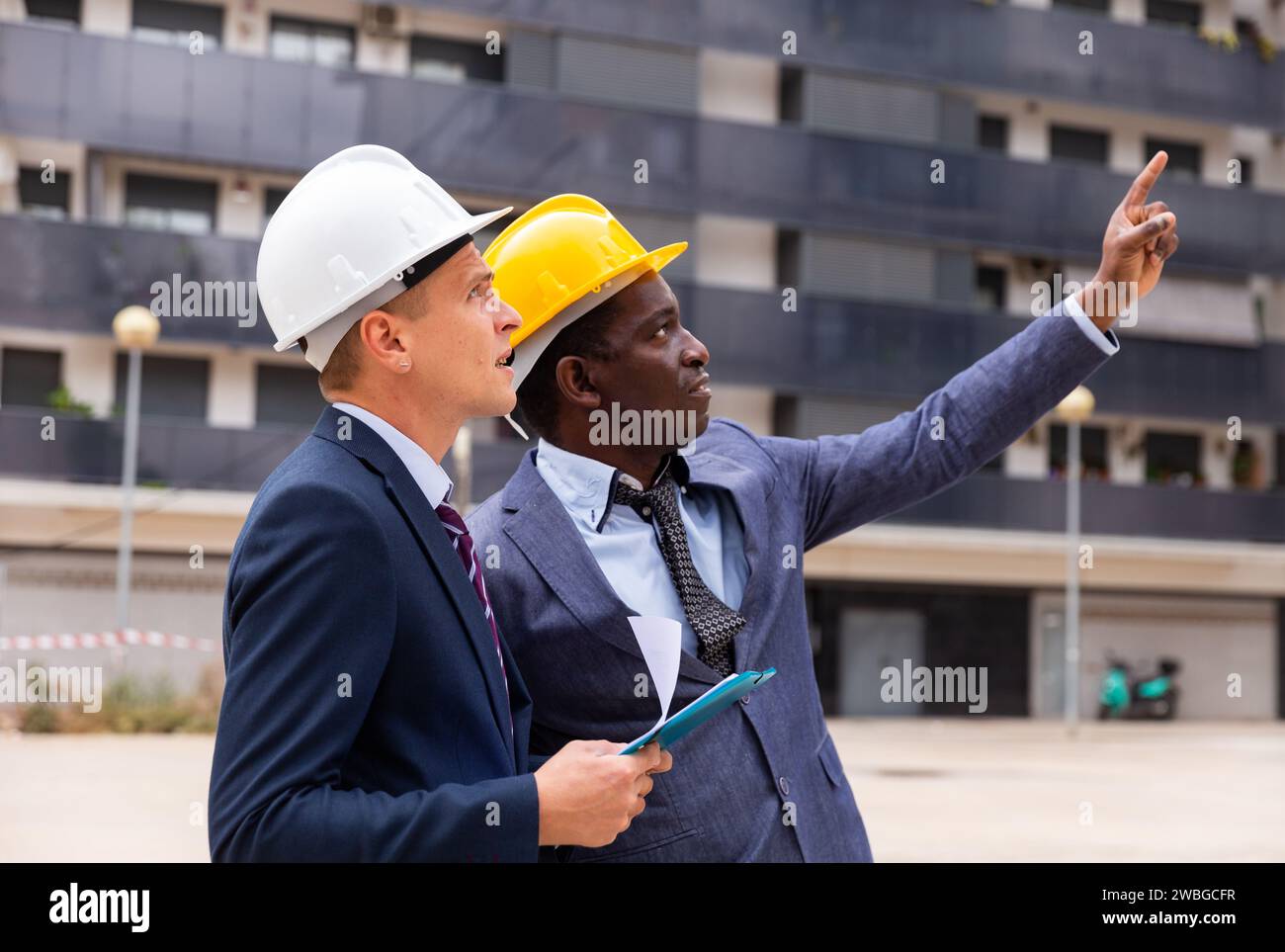 Two architect, civil engineer or building contractor colleagues on ...