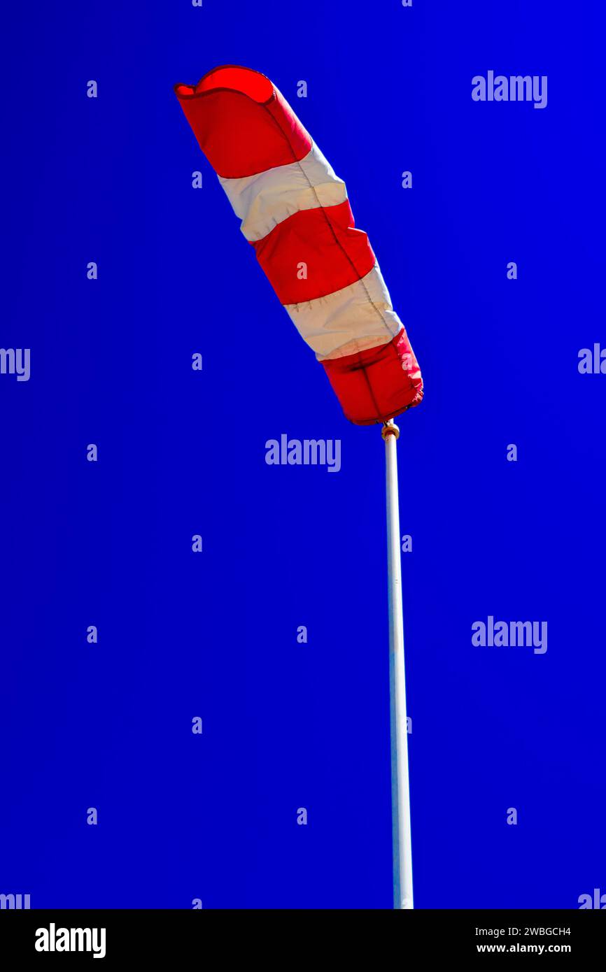 windsock in operation with strong blue sky background Stock Photo - Alamy