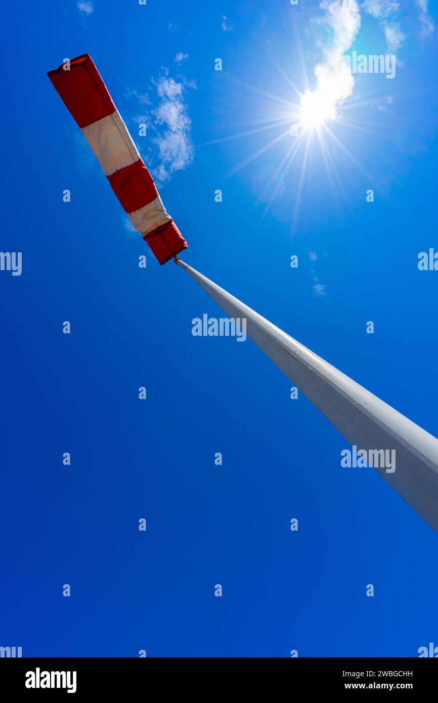 windsock in operation with strong blue sky background with sun Stock ...