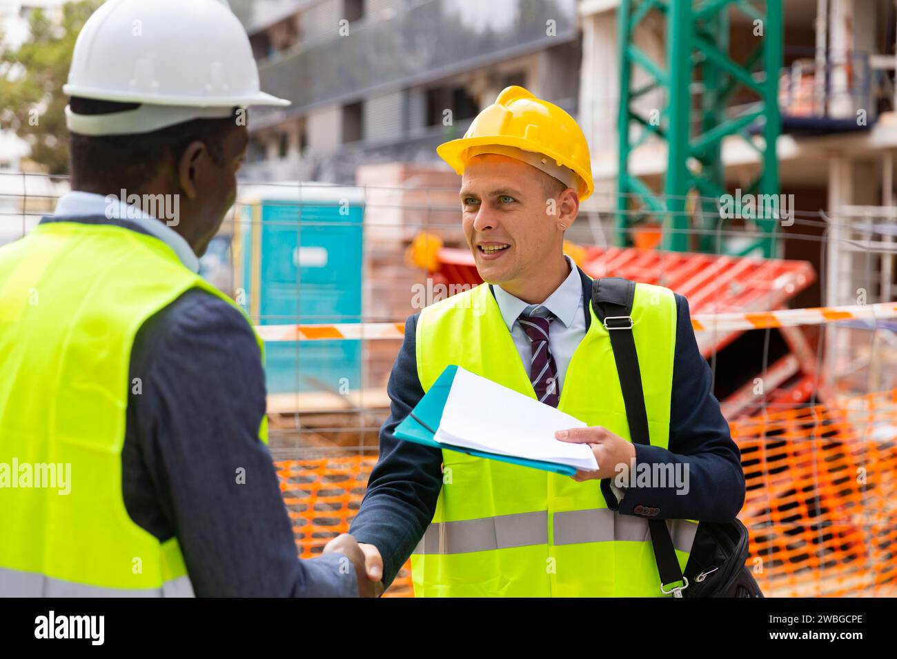 Two successful civil engineers exchange a friendly handshake Stock ...