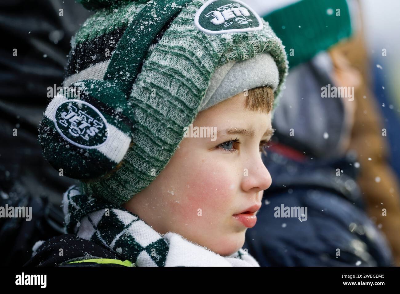 A young New York Jets fan observes warm-ups before the start of an NFL ...