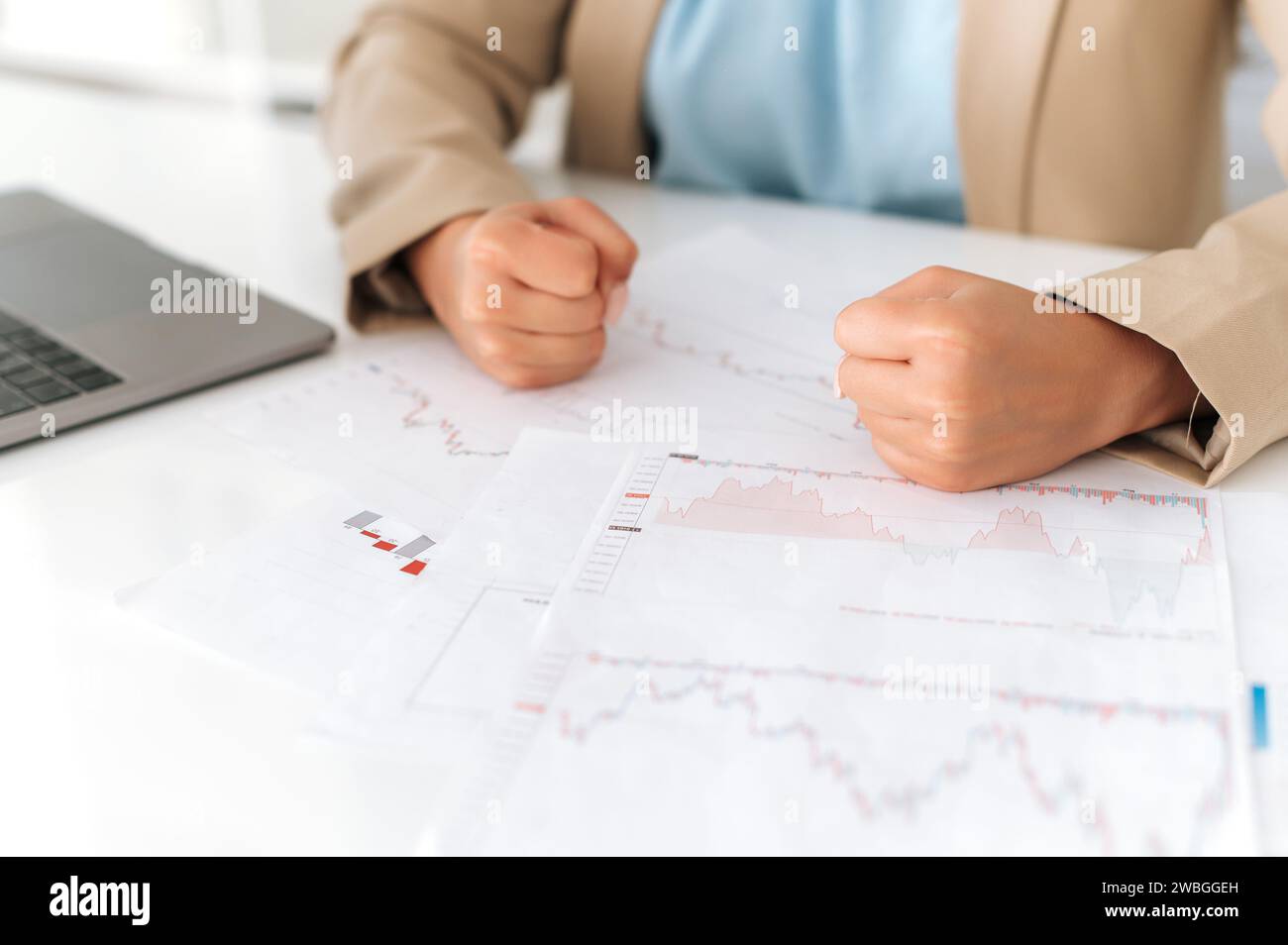 Business, trading, stock market. Graphs on the desktop and female fists ...