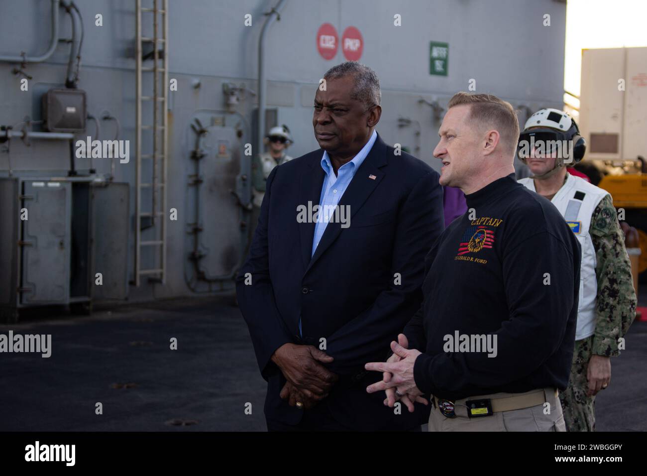 U.S. Secretary of Defense Lloyd J. Austin III, center, speaks with Capt ...