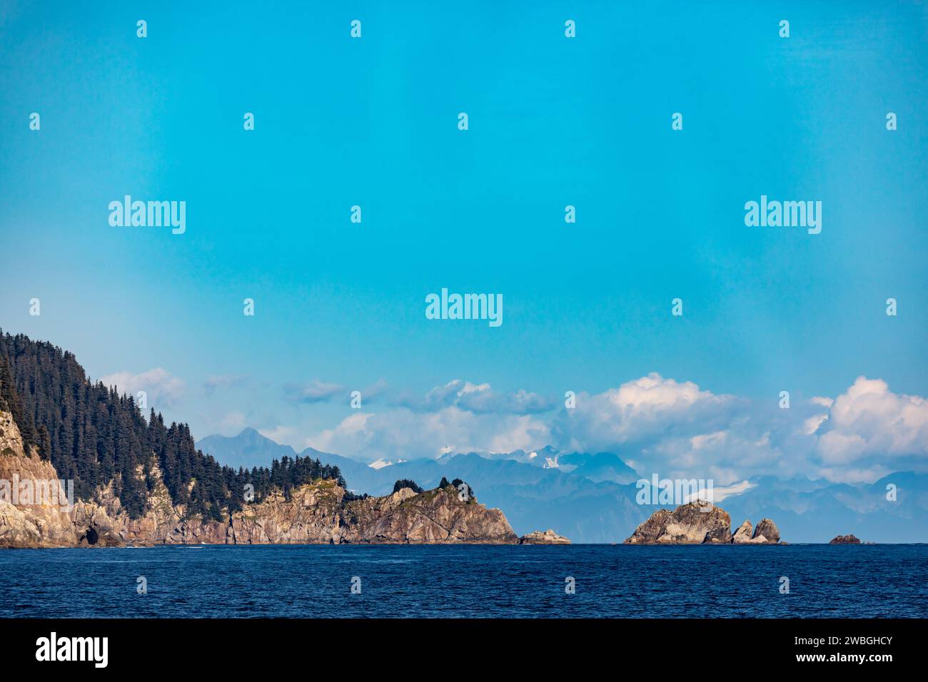 Rugged Alaska coastline and blue mountain ranges Stock Photo - Alamy