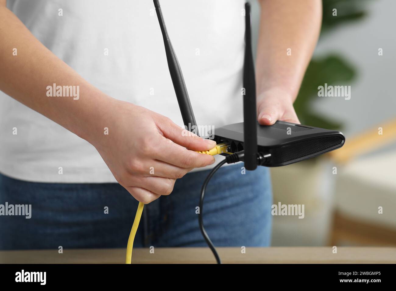 Hands ethernet cable router hi-res stock photography and images - Alamy