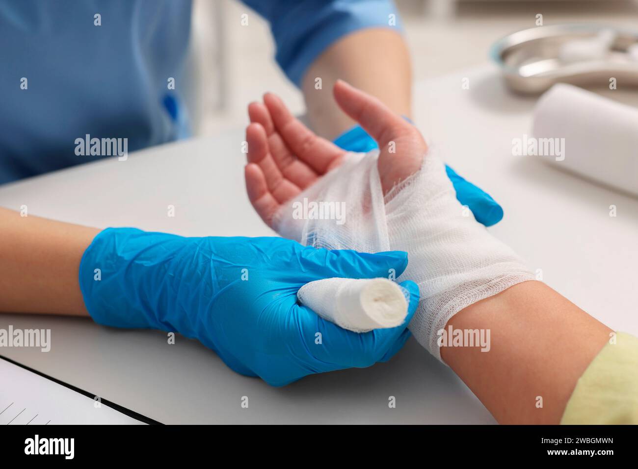 Doctor bandaging patient's burned hand indoors, closeup Stock Photo - Alamy