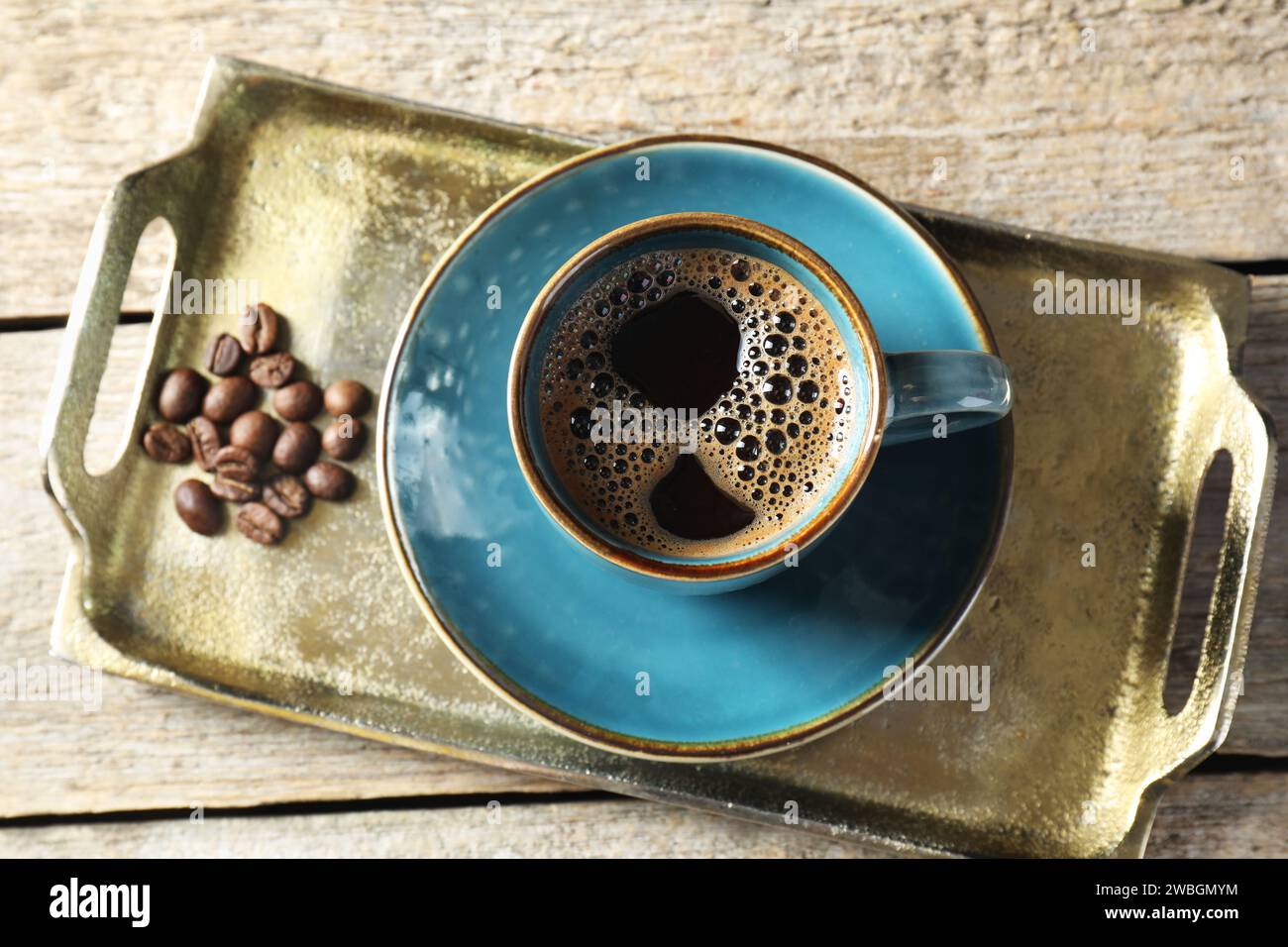 Turkish coffee. Freshly brewed beverage and beans on wooden table, top ...