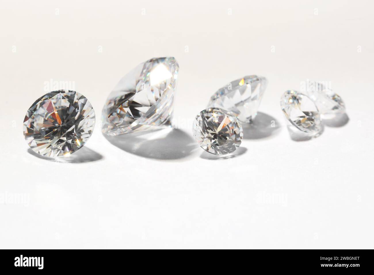 Many beautiful shiny diamonds on white background Stock Photo - Alamy