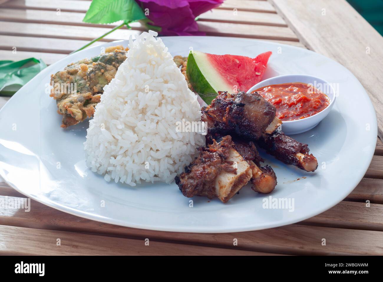 Grilled beef oxtail rice served with chili sauce and fruit Stock Photo ...