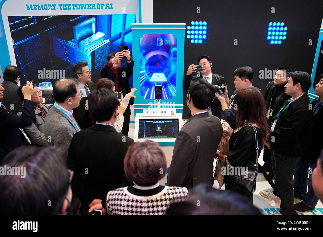 People crowd around an AI Fortune Teller at the SK booth during the CES tech show Wednesday, Jan ...