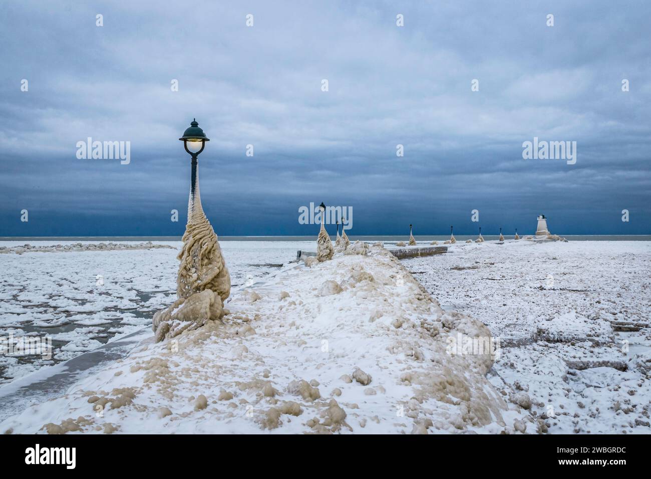 Lake Erie pier in Ontario, Canada, ight posts covered in ice. Natural ...