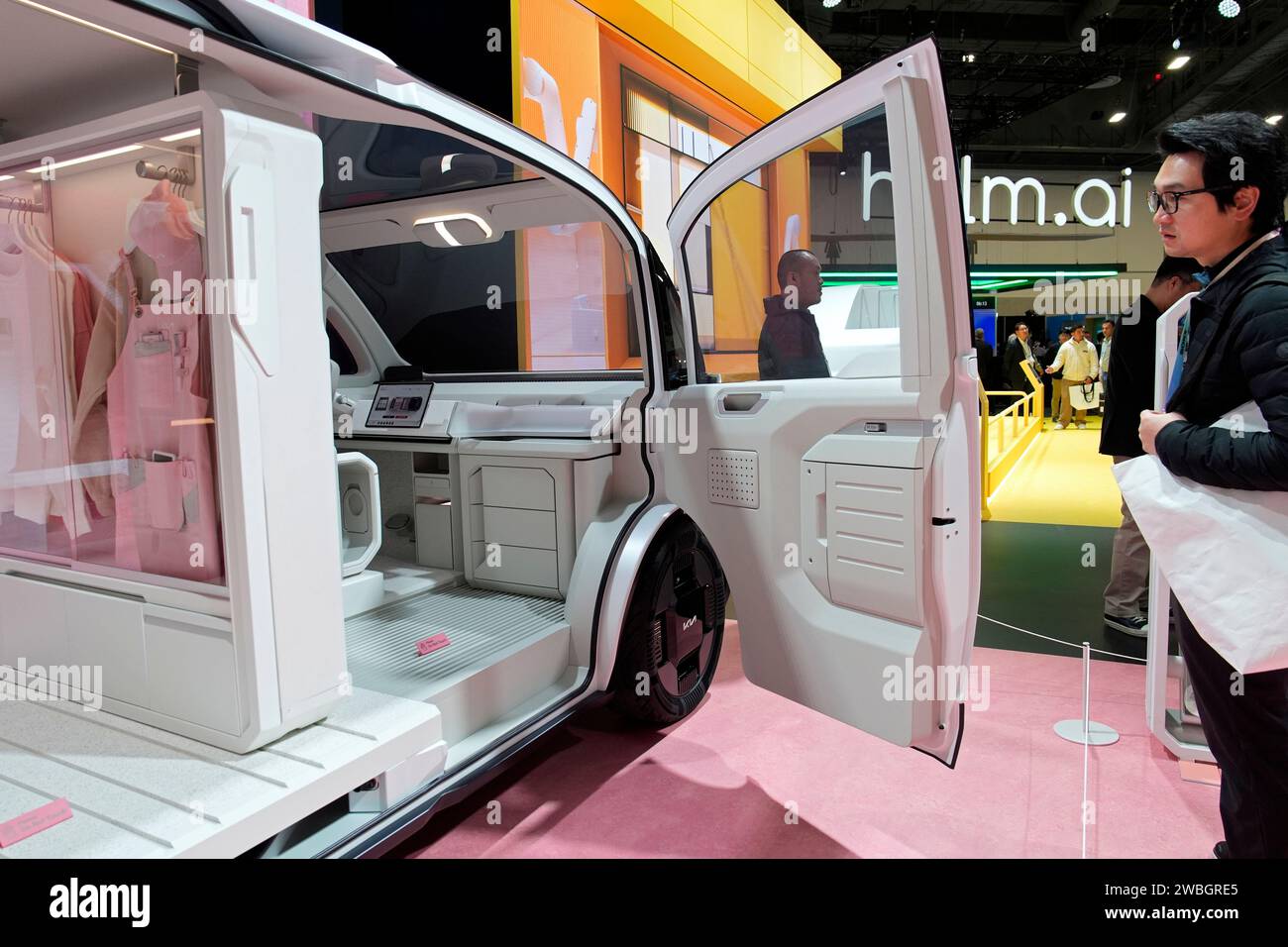 People look at the Kia PV7 electric vehicle concept at the Kia booth ...