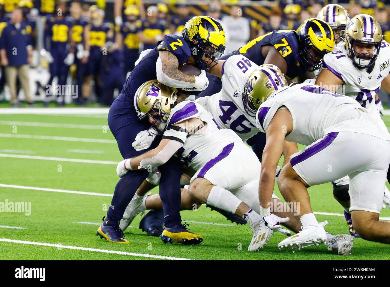 Houston, TX, USA. 8th Jan, 2024. Michigan Wolverines running back Blake Corum (2) is tackled by ...