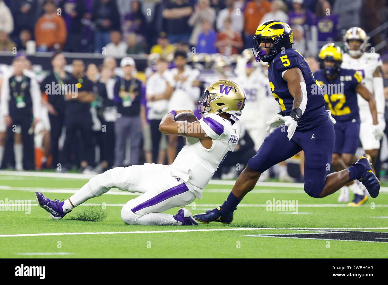 January 8, 2024: Washington Huskies quarterback Michael Penix Jr. (9) slides after a run during ...