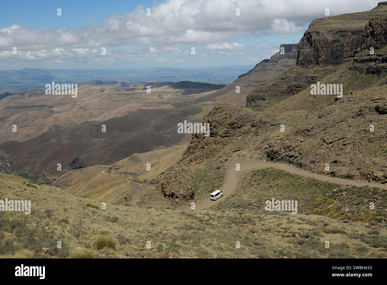 African taxi bus driving up Sani mountain pass, Drakensberg landscape ...