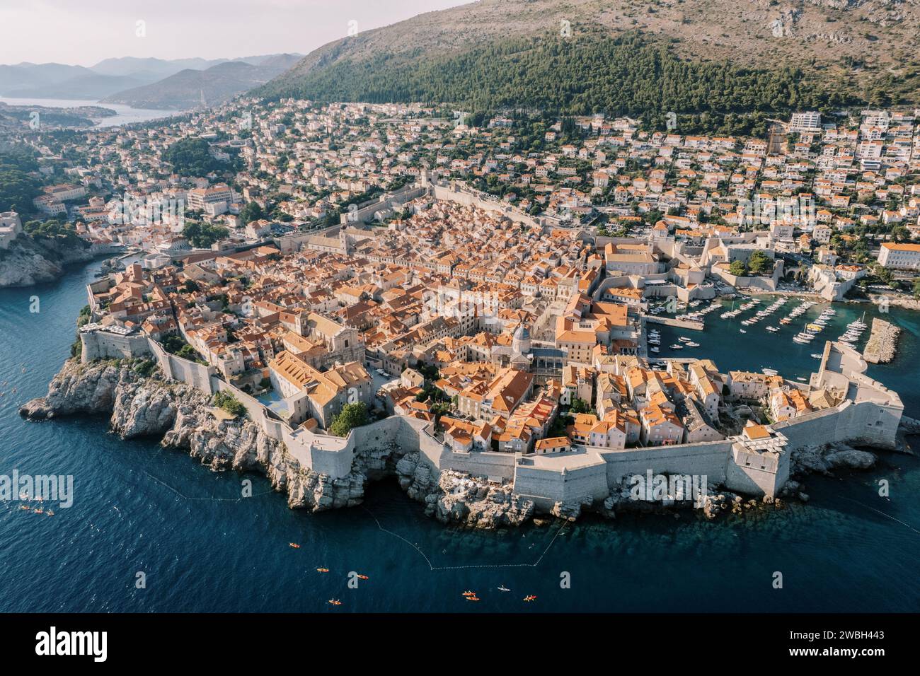High fortress walls around stone houses in the old town. Dubrovnik ...